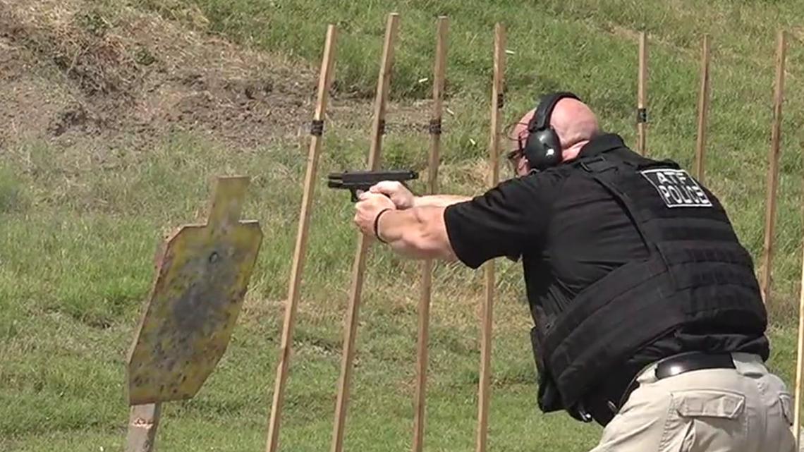 BATF agent demonstrates a 'switch' used to convert a Glock handgun to ...