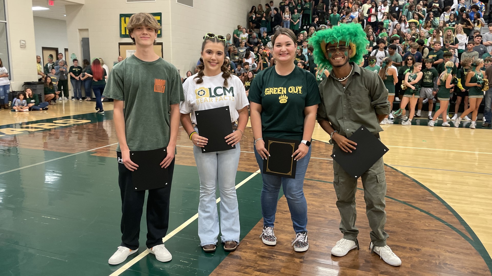 Students honored for cleaning up trash at football stadium | 12newsnow.com